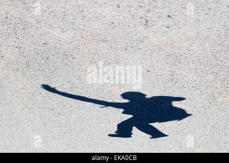 shadow of a man jumping on the asphalt Stock Photo - Alamy