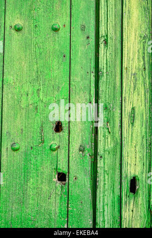 Strongly weathered wooden planks with peeling paint, showcasing rough ...