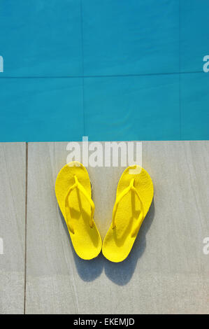 Sandals by a swimming pool Stock Photo - Alamy