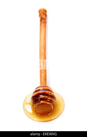 Honey dipper with pool of honey on white plate Stock Photo - Alamy