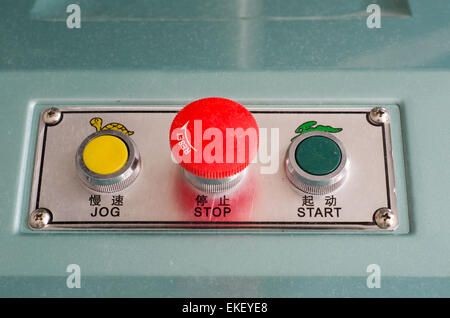 Industrial machine start stop and jog buttons in English and Chinese ...