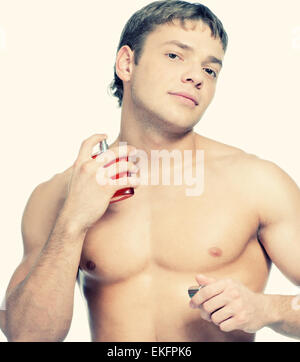 Cosmetic wellness man spraying fragrance Stock Photo - Alamy
