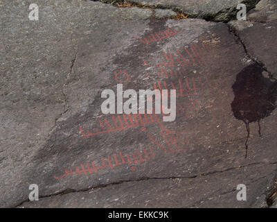 Norwegian petroglyphs or rock engravings, enhanced with red paint ...