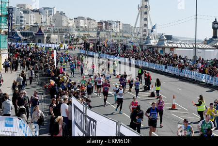 Brighton, UK. 12th April, 2015. Runners pass by the Royal Pavilion as ...