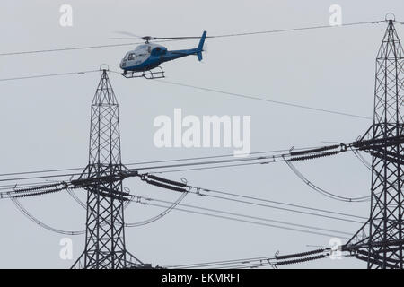 National Grid Inspecting power lines helicopter Stock Photo - Alamy