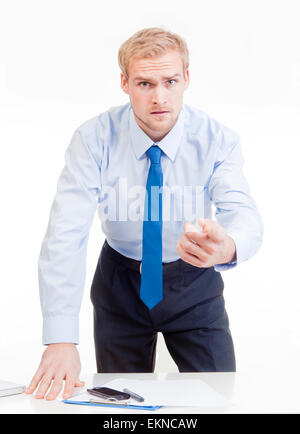 Angry businessman behind the desk Stock Photo - Alamy