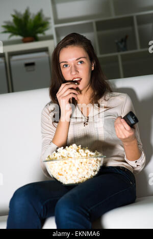 Portrait of a happy woman woman watching TV Stock Photo - Alamy
