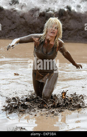 Mid 20s-30s blonde woman emerges from mud pool at finish line of an ...