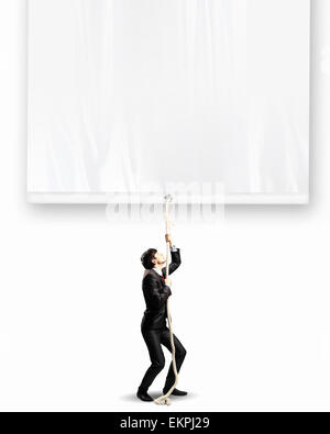 Image of businessman pulling blank banner. Place for text Stock Photo ...
