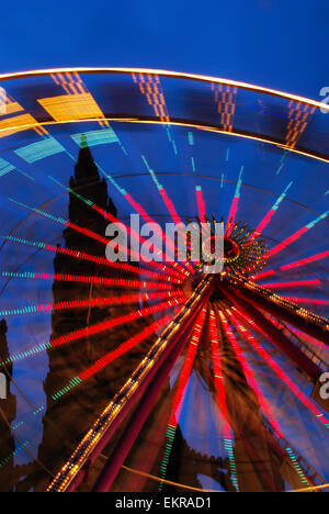 The Edinburgh Wheel in front of the Scott Monument with blurred traffic ...