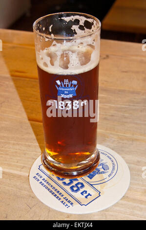 A printed glass of Schumacher 1838 Alt Altbier dark ale on a bar in ...