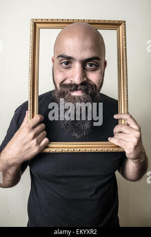 funny bearded man with golden frame Stock Photo - Alamy