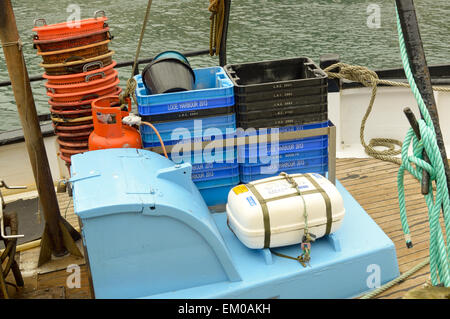 Fish storage containers stacked on shipping pallets with cached fish in ...