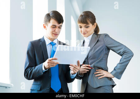 two business partners discussing reports Stock Photo - Alamy