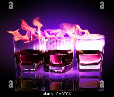 Three glasses of burning purple absinthe Stock Photo - Alamy