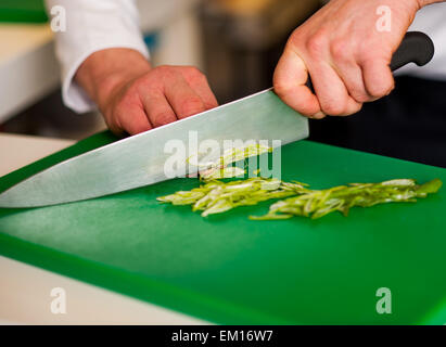 Chef chopping leek, doing preparations Stock Photo - Alamy