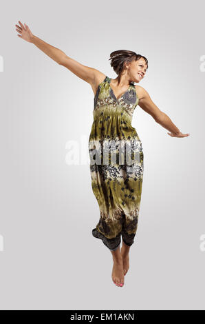 pretty modern slim hip-hop style woman jumping dancing on a colour ...
