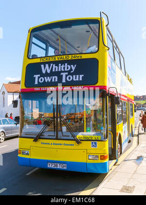 A double decker Whitby Town Tour bus in the historical port of Whitby ...