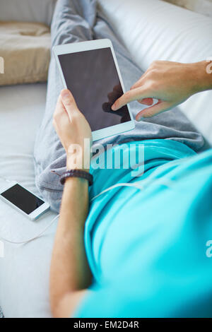 Young man using modern gadgets Stock Photo - Alamy