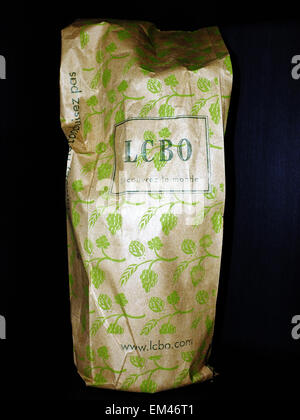 A bottle of alcohol in a brown paper bag isolated on a white Stock ...