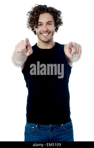 Smart guy pointing towards camera Stock Photo - Alamy
