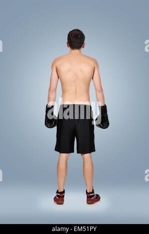 Portrait of a handsome fit muscular boxer man standing isolated over ...