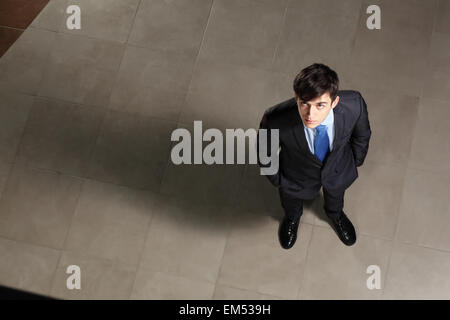 Image of young businessman looking above. Top view Stock Photo - Alamy