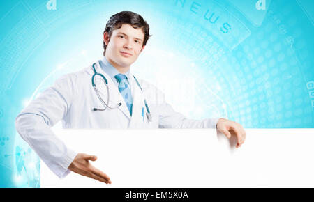 Young smiling doctor with blank banner. Place for text Stock Photo - Alamy