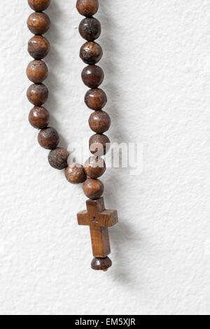 A rosary on a white wall Stock Photo - Alamy