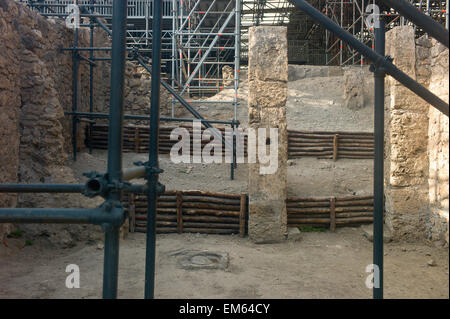 Scaffolding and props supporting building walls at the archaeological ...