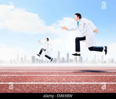 Funny image of young running doctor in white uniform Stock Photo - Alamy