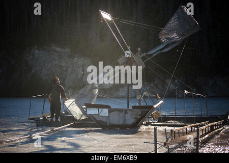 A man works on his family's fish wheel on the Copper River, near ...
