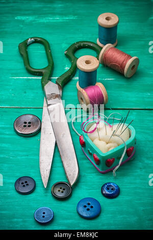 thread buttons for crafts on turquoise wooden background.Selective ...