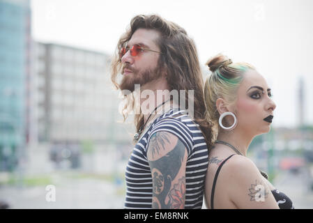 Portrait of punk hippy couple side by side on city street Stock Photo ...