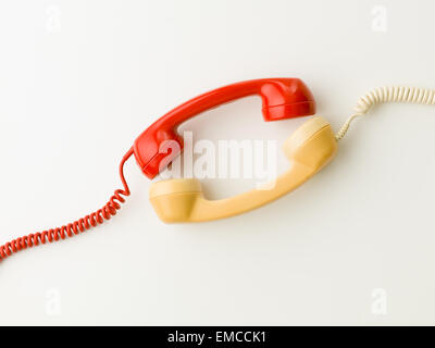 Two telephone handsets facing each other and talking Stock Photo - Alamy