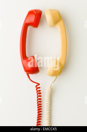 Two telephone handsets facing each other and talking. Copy space Stock ...