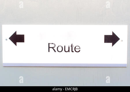 Route direction notice board on wooden background Stock Photo - Alamy