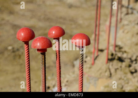 Concrete reinforcing steel with safety caps on a construction site ...