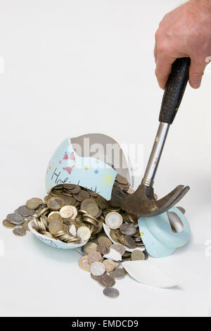 Smashed Money box with Coins pouring out of it on a white background ...