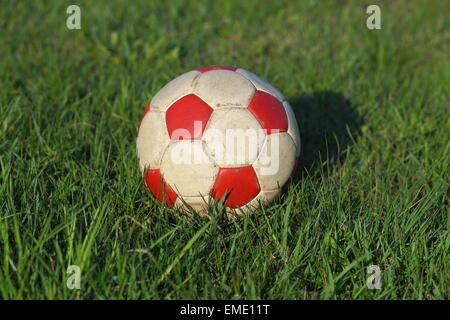 Worn out football on pitch Stock Photo - Alamy