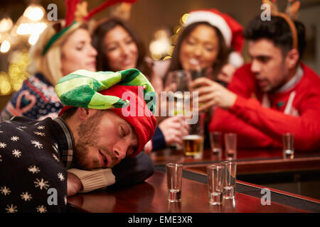 Man Passed Out On Bar During Christmas Drinks With Friends Stock Photo ...