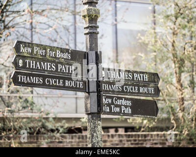 Kew sign on River Thames tow path showing distances to Kew Gardens and ...