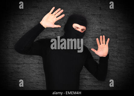 robber raised his hands up on gray background Stock Photo - Alamy