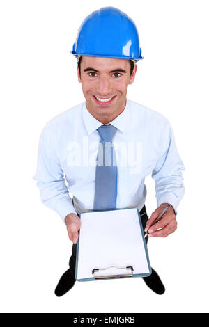smiling engineer holding clipboard with blank sheet and spirit level ...