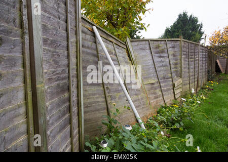 Storm damage wooden fence panels collapsed Stock Photo - Alamy