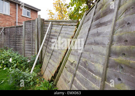 Storm damage wooden fence panels collapsed Stock Photo - Alamy