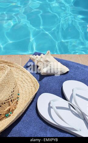 Cowboy hat conch shell towel by swimming pool Stock Photo - Alamy