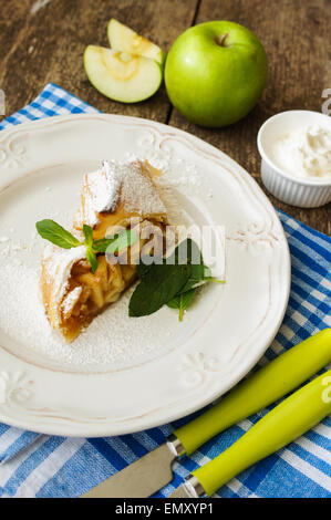 Viennese strudel with vanilla sauce on the old wooden table Stock Photo ...