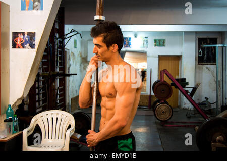 Bodybuilder Lifting Weightlifting Bar At Rusty Gym Stock Photo - Alamy