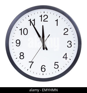 Clock face showing 5 minutes to 12 o'clock Stock Photo - Alamy